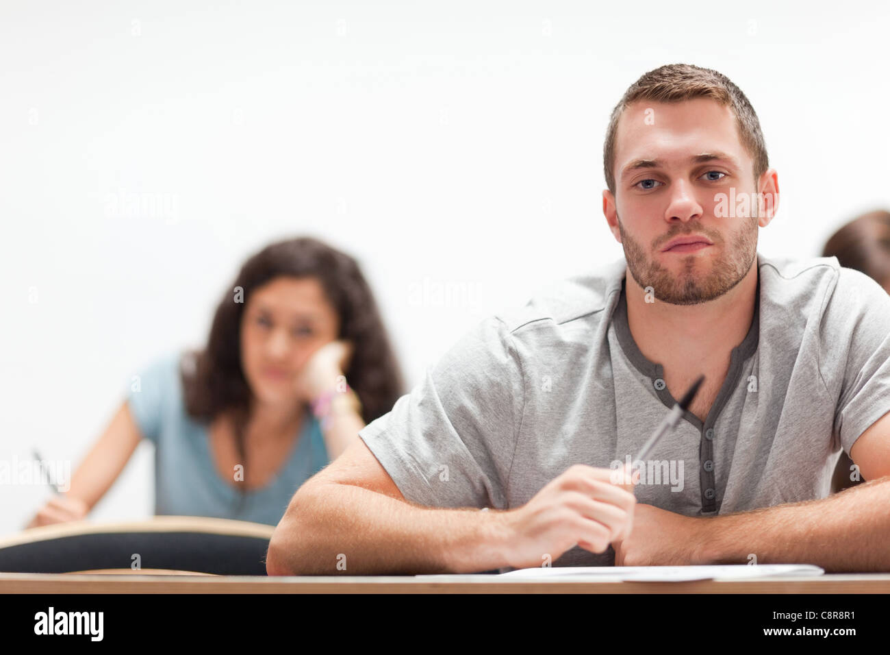 Smiling handsome student sitting Stock Photo - Alamy