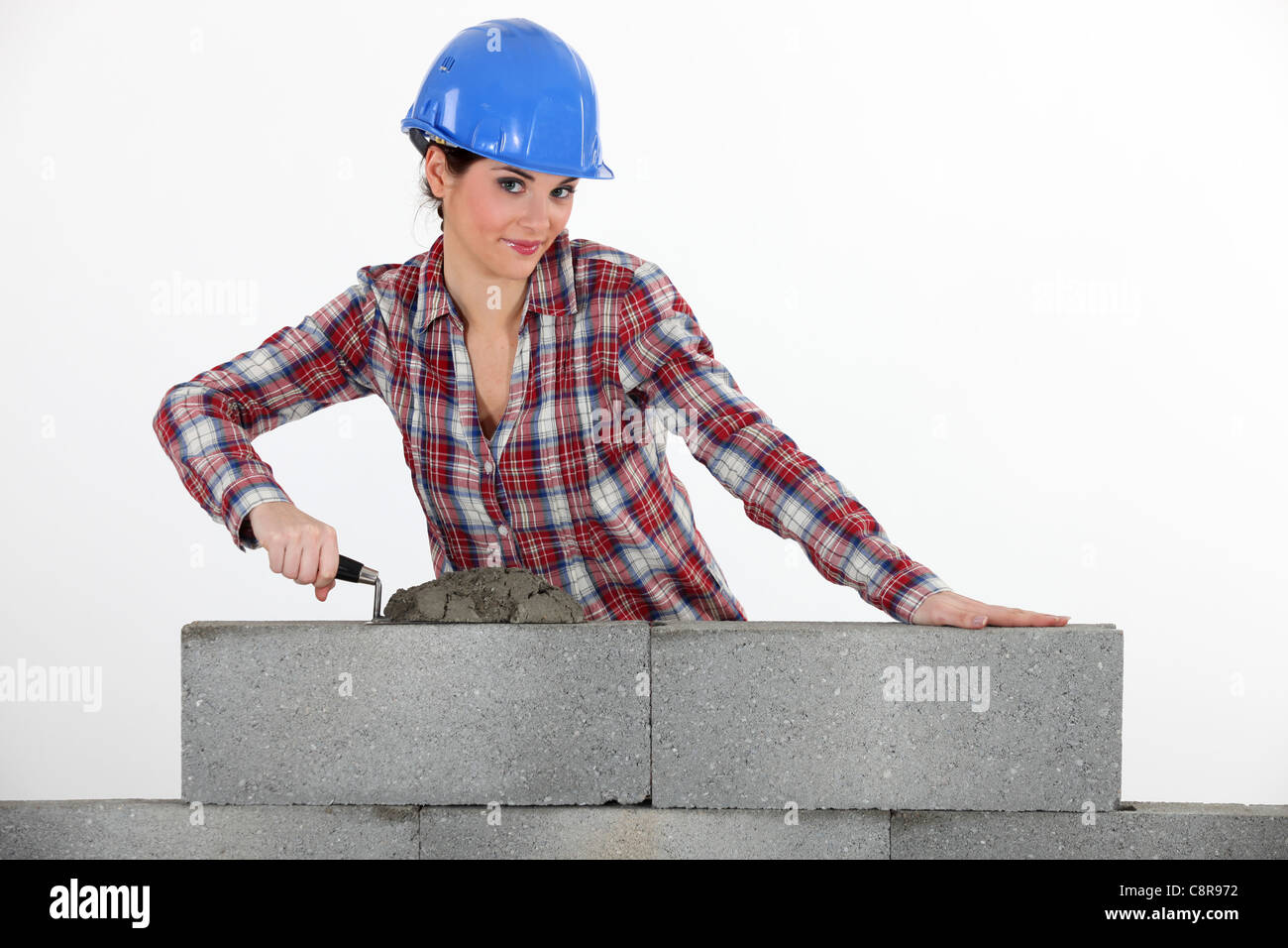 Woman building wall Stock Photo - Alamy