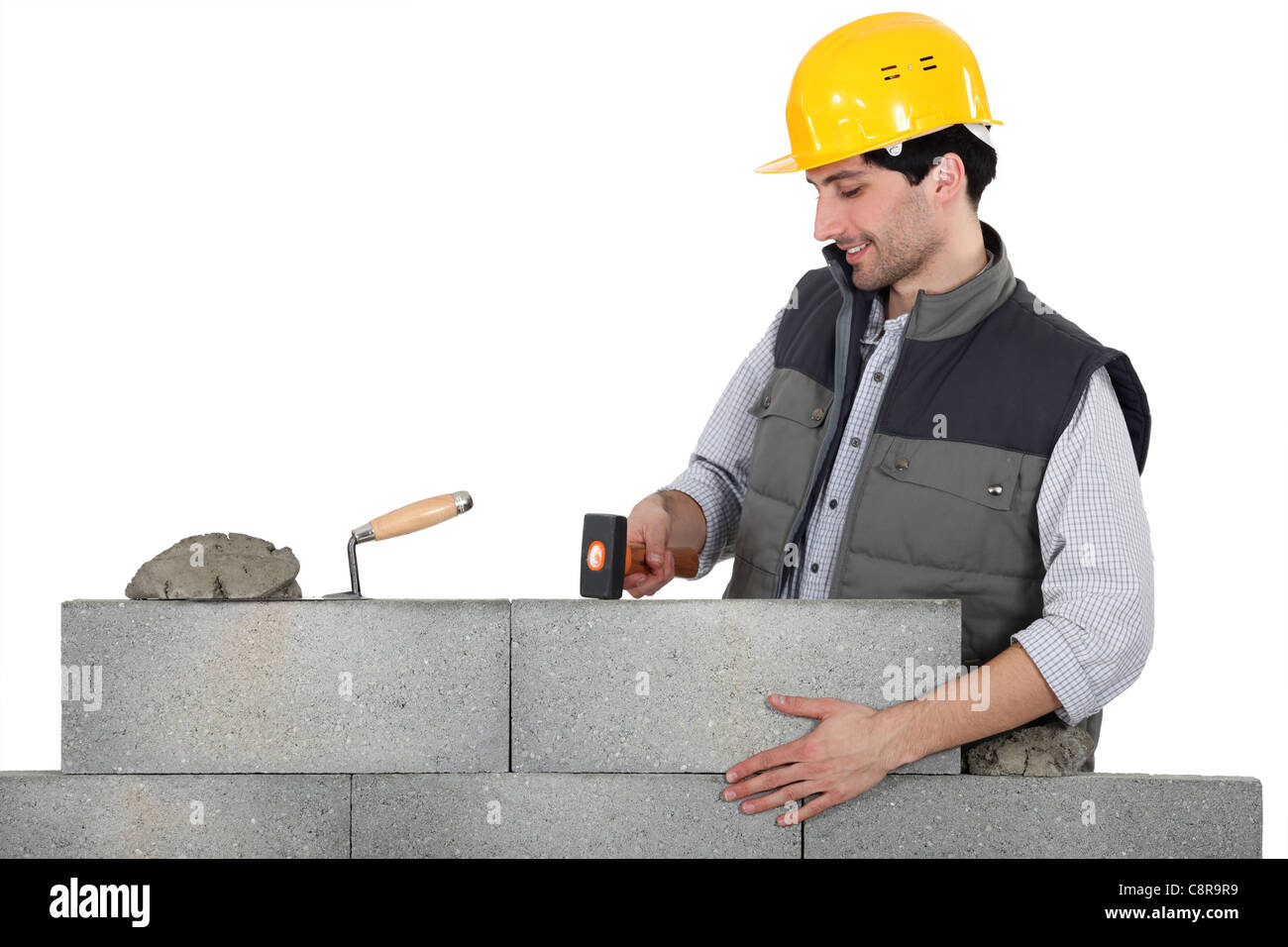 Mason mounting a brick wall Stock Photo - Alamy