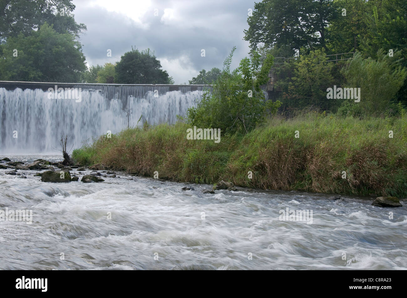 Cascading waters and rapids at base of Root River dam and waterfall in ...