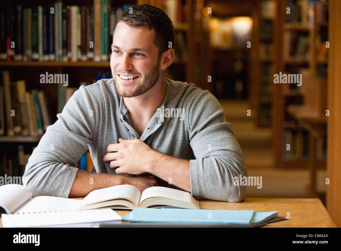 Smiling male student working Stock Photo - Alamy