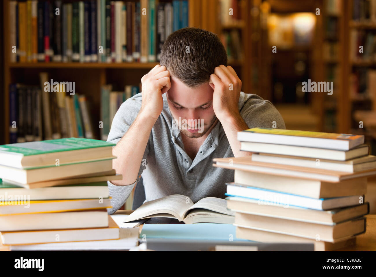 Tired student having a lot to read Stock Photo - Alamy
