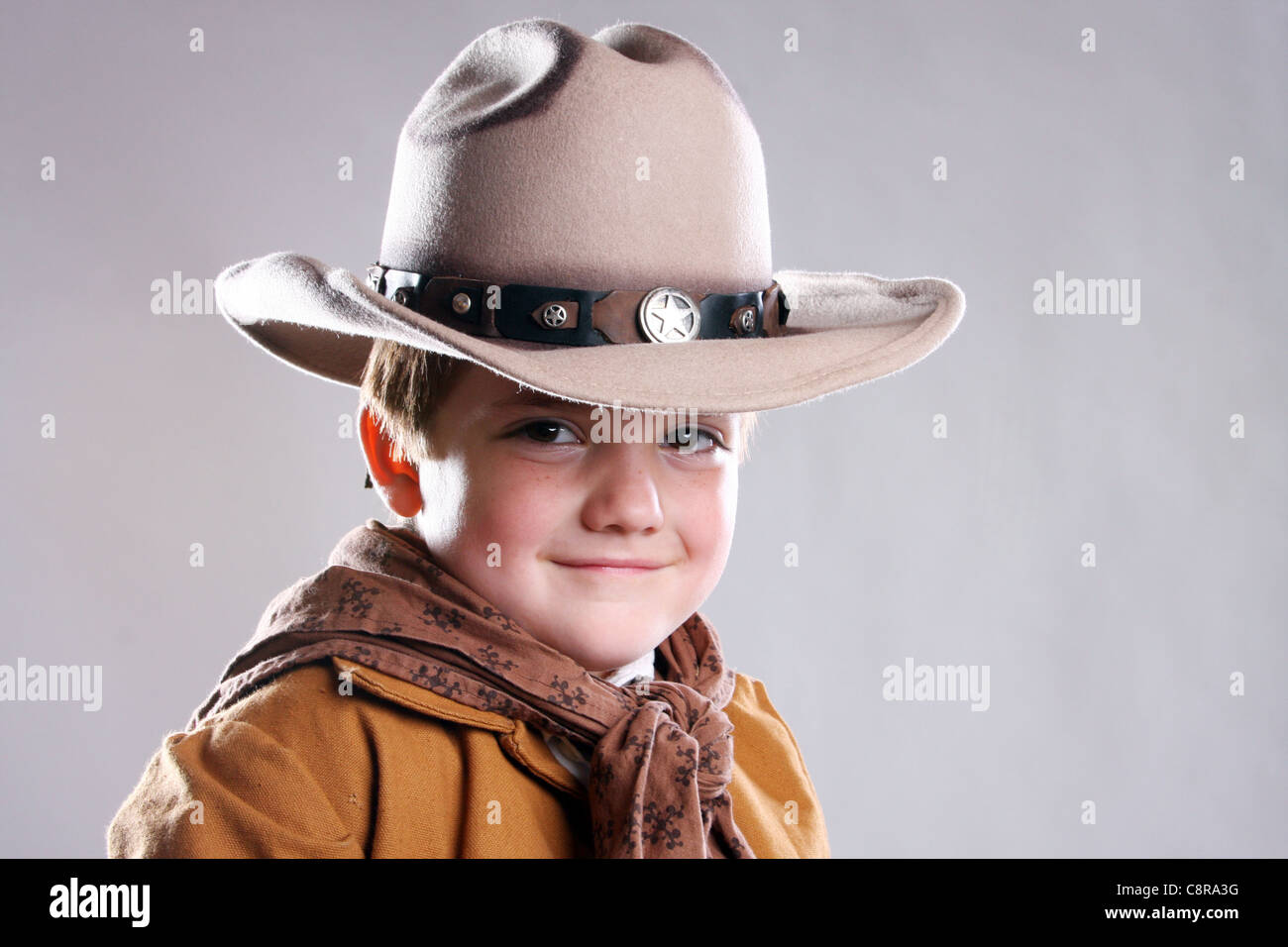 A young cowboy child smiling Stock Photo - Alamy