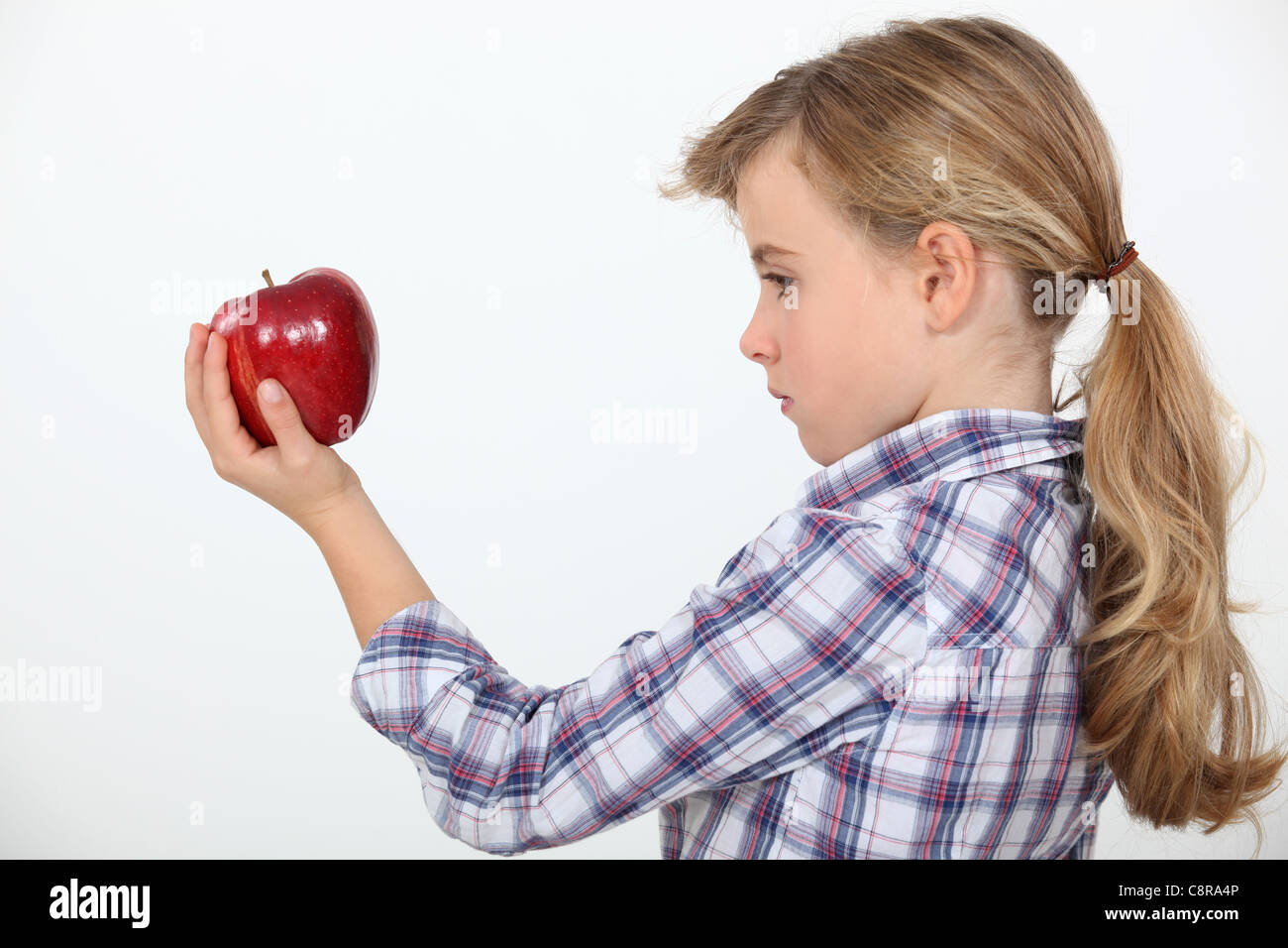 Girl holding an apple Stock Photo - Alamy