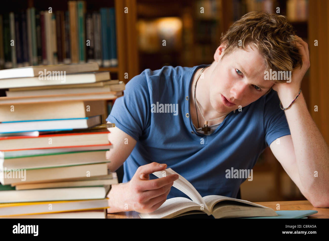 Tired man with a book Stock Photo - Alamy