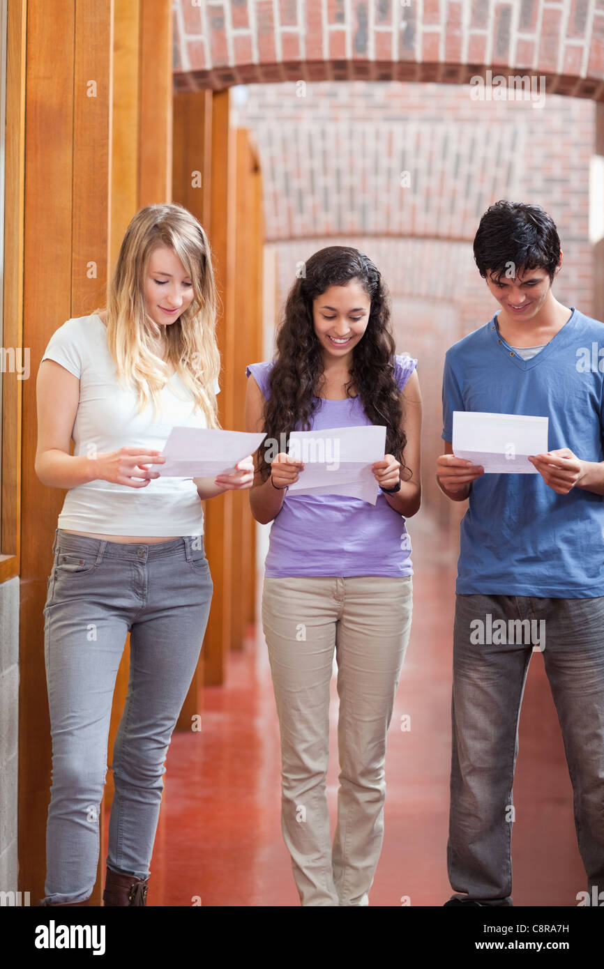 Portrait of students reading a piece of paper Stock Photo - Alamy