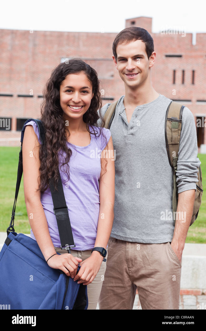 Portrait of a smiling student couple posing Stock Photo - Alamy