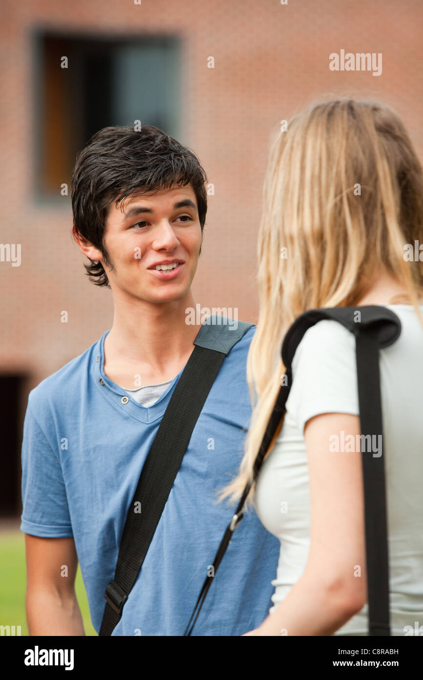 Portrait of a surprised student talking with a friend Stock Photo - Alamy