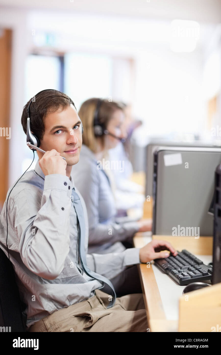 Portrait of a customer assistant using a headset Stock Photo - Alamy