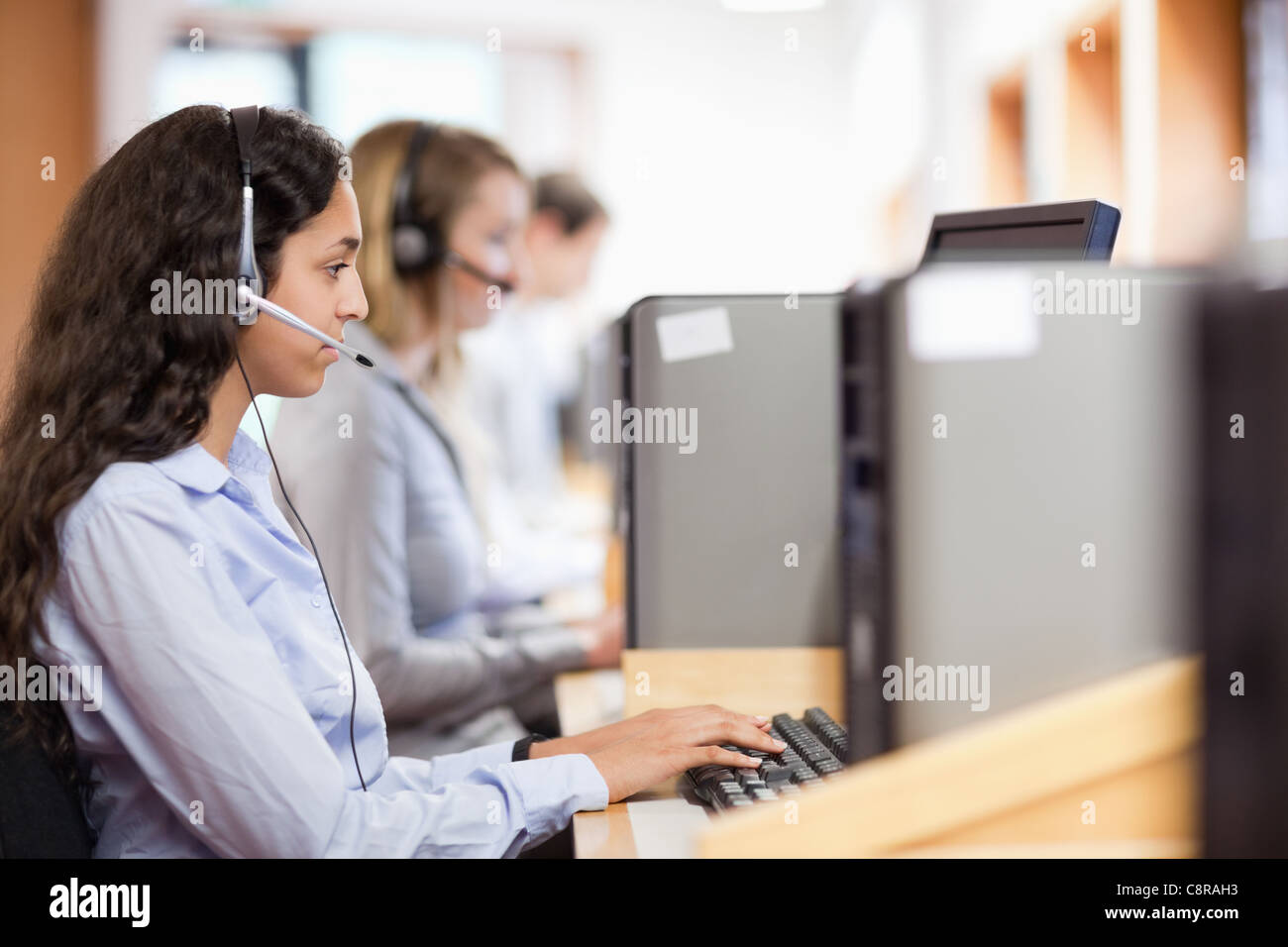 Customer assistant working with a computer Stock Photo - Alamy