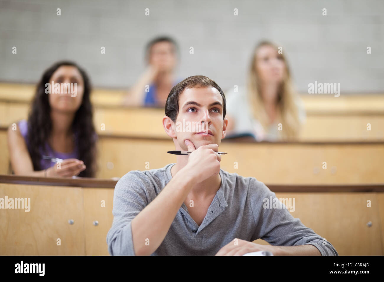 Serious students listening during a lecture Stock Photo - Alamy