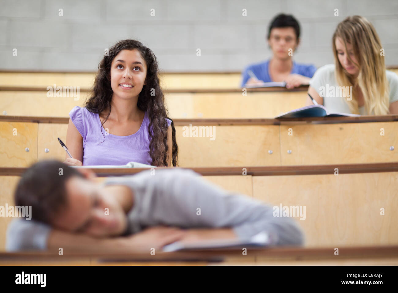 Students listening while their classmate is sleeping Stock Photo - Alamy
