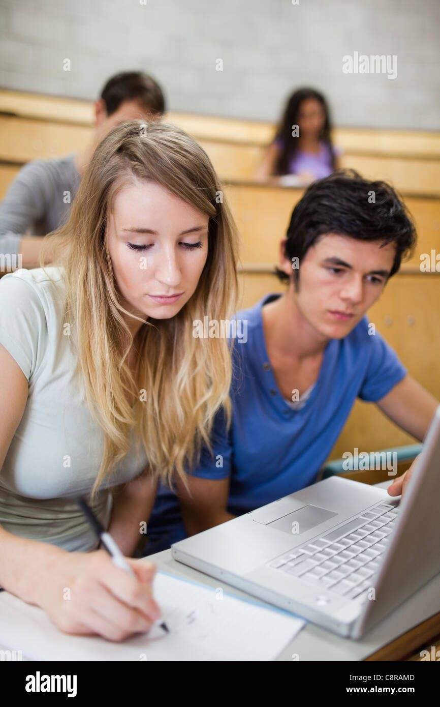 Portrait of students working with a notebook Stock Photo - Alamy
