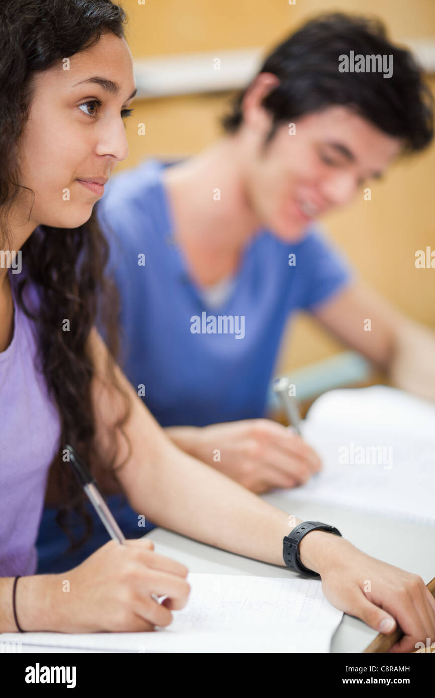 Portrait of smiling students writing Stock Photo - Alamy