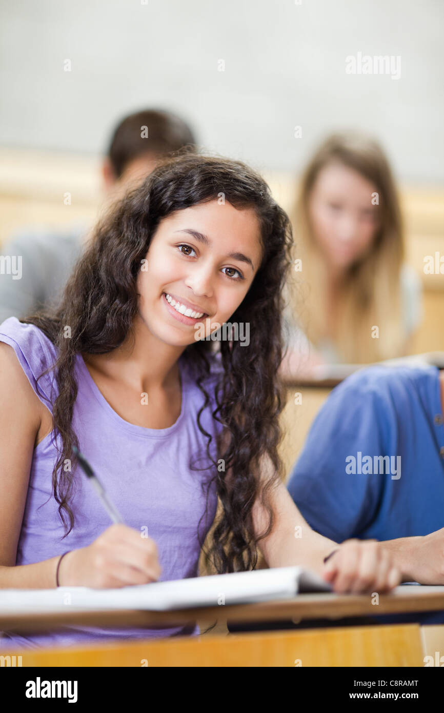 Portrait of a smiling student taking notes Stock Photo - Alamy