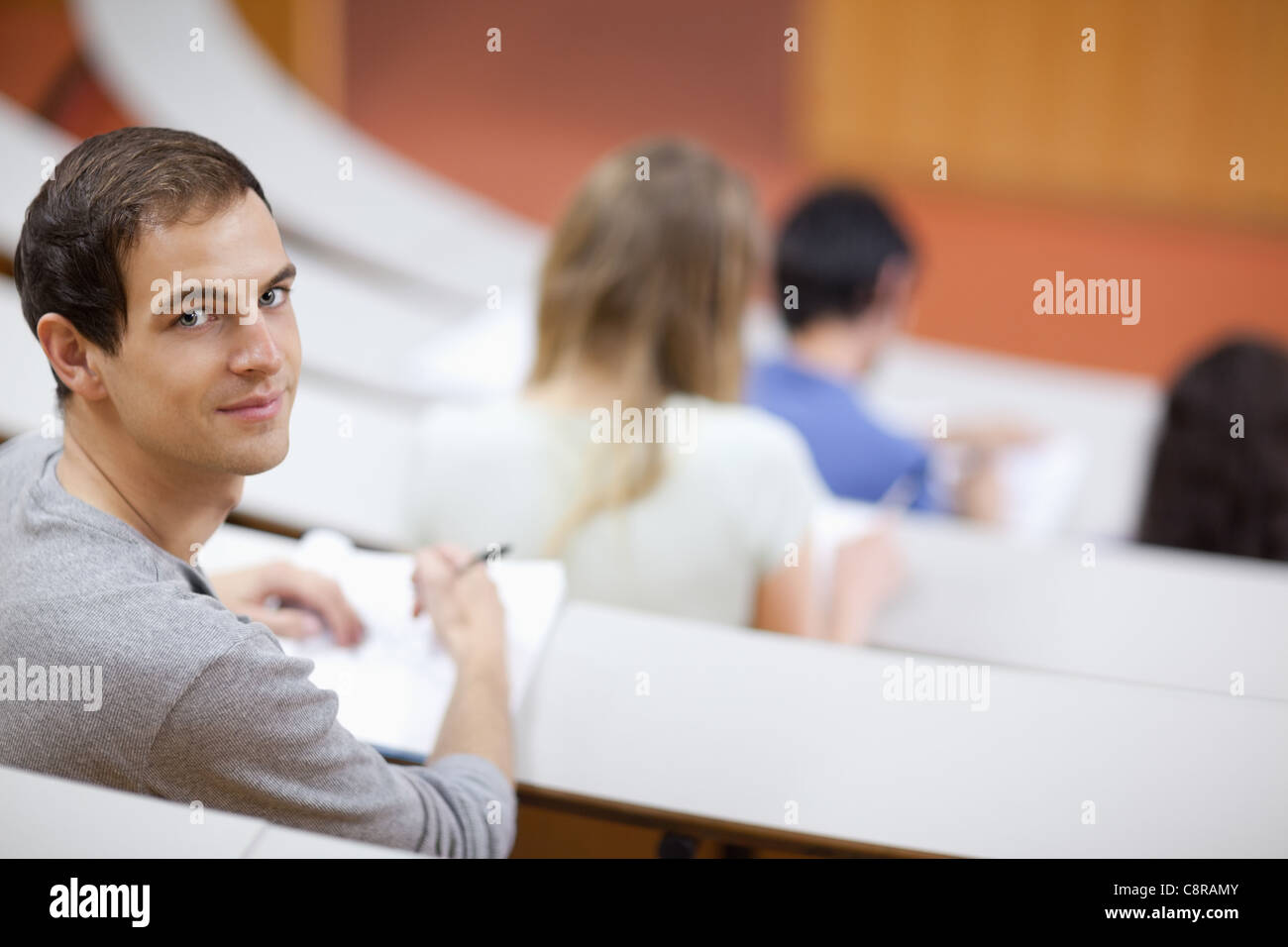 Smiling student being distracted Stock Photo - Alamy