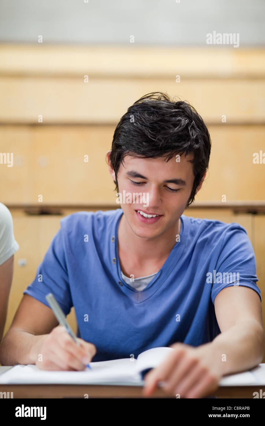 Portrait of a handsome young student taking notes Stock Photo - Alamy