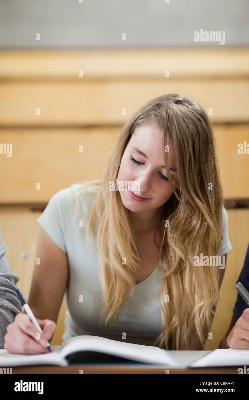 Portrait of a cute student writing on a notepad Stock Photo - Alamy