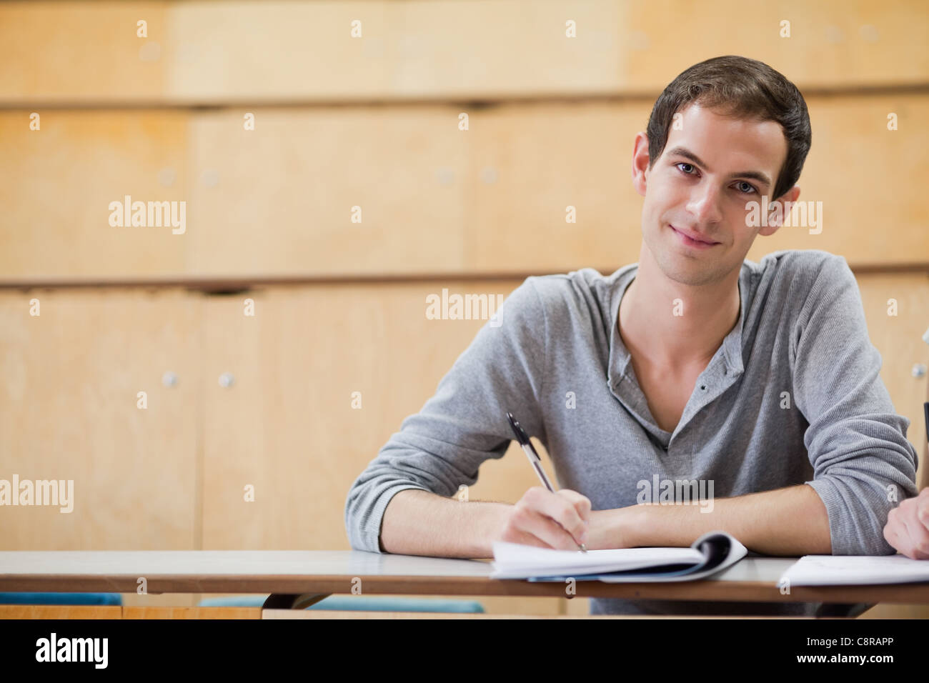 Male student holding a pen Stock Photo - Alamy