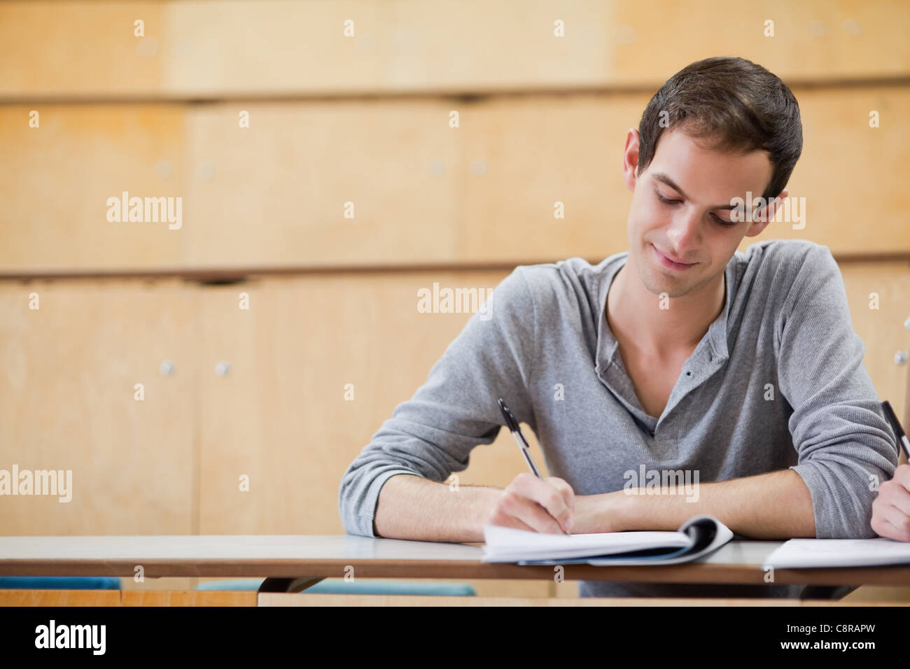Male student writing notes Stock Photo - Alamy