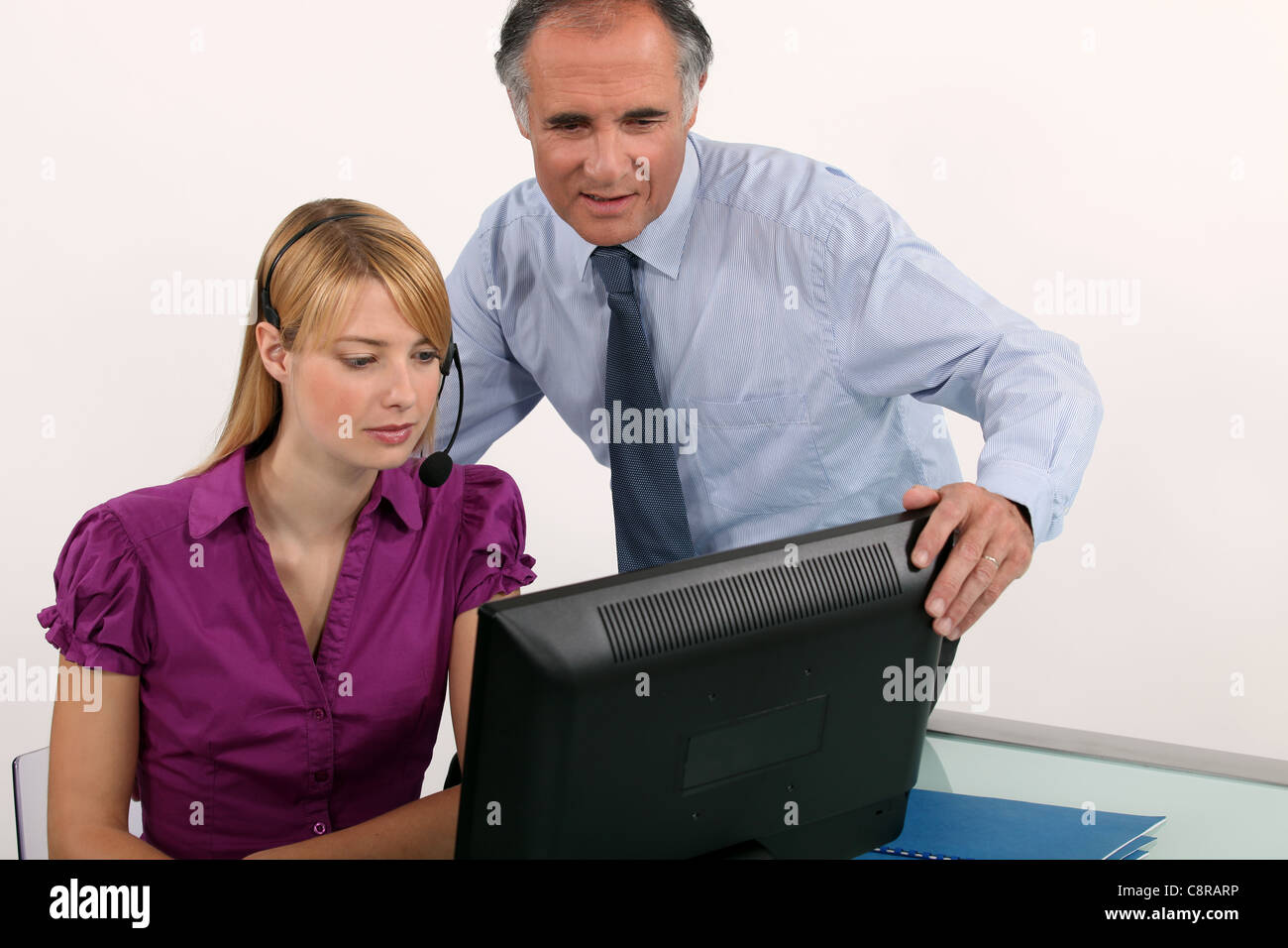 Woman and her boss at a computer Stock Photo - Alamy