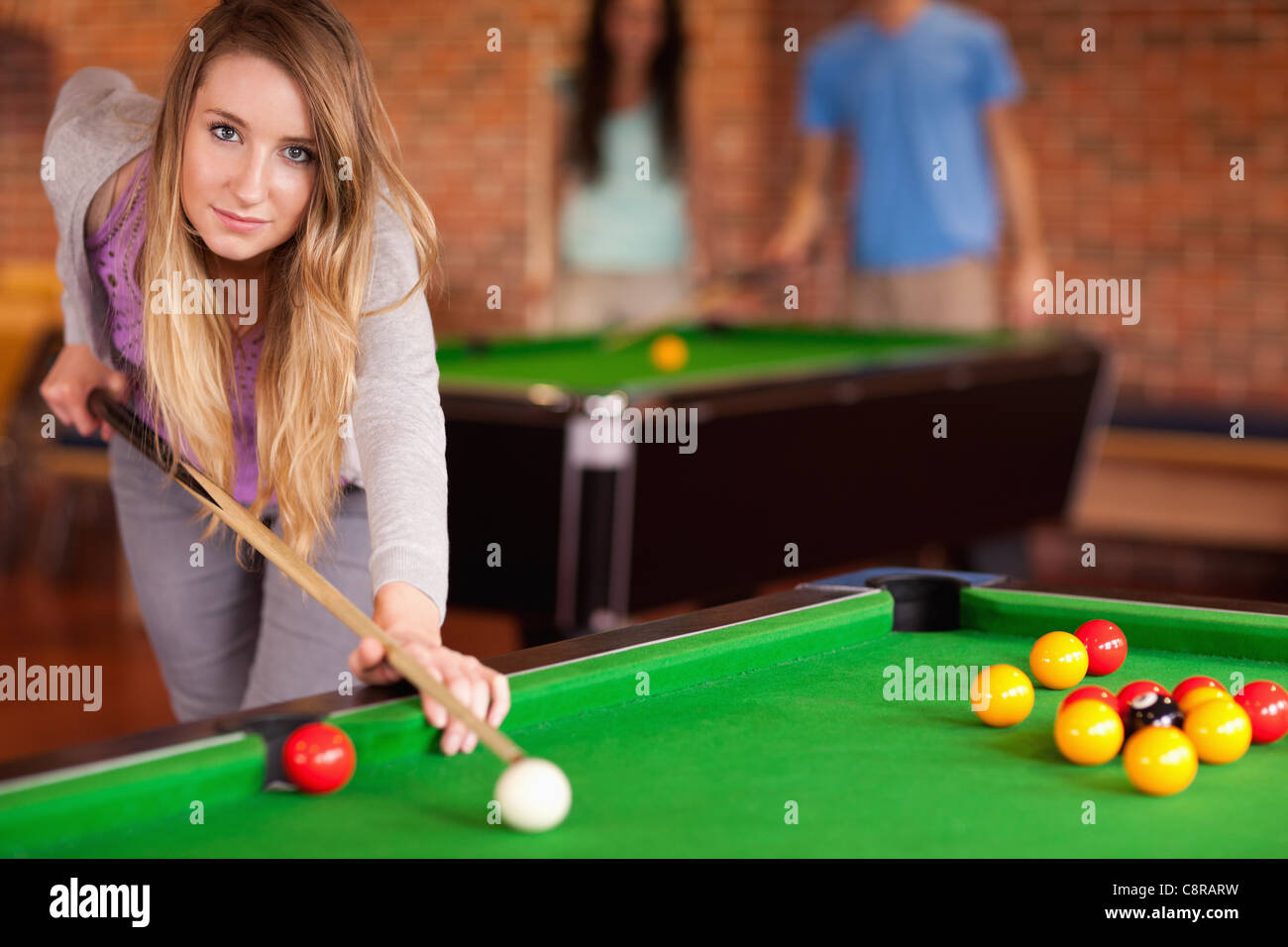 Cute woman playing snooker Stock Photo - Alamy