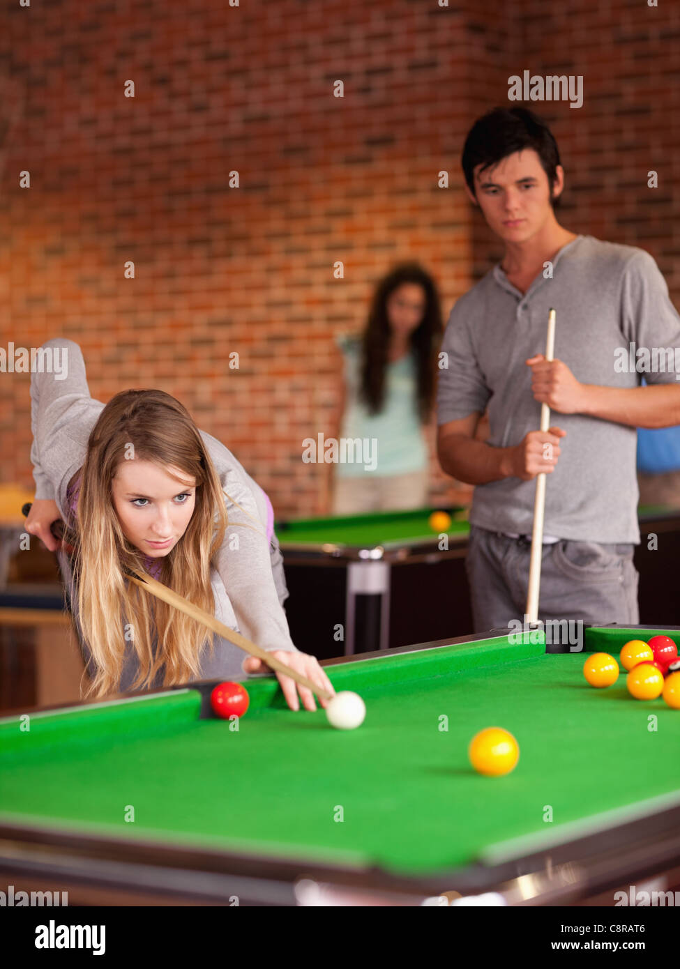 Portrait of friends playing snooker Stock Photo - Alamy