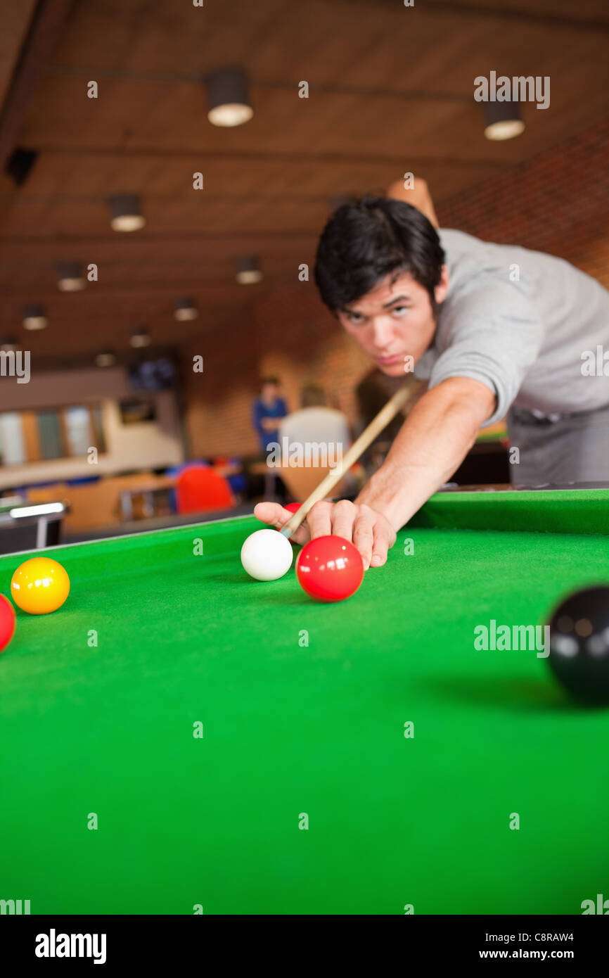 Portrait of a student playing pool Stock Photo - Alamy