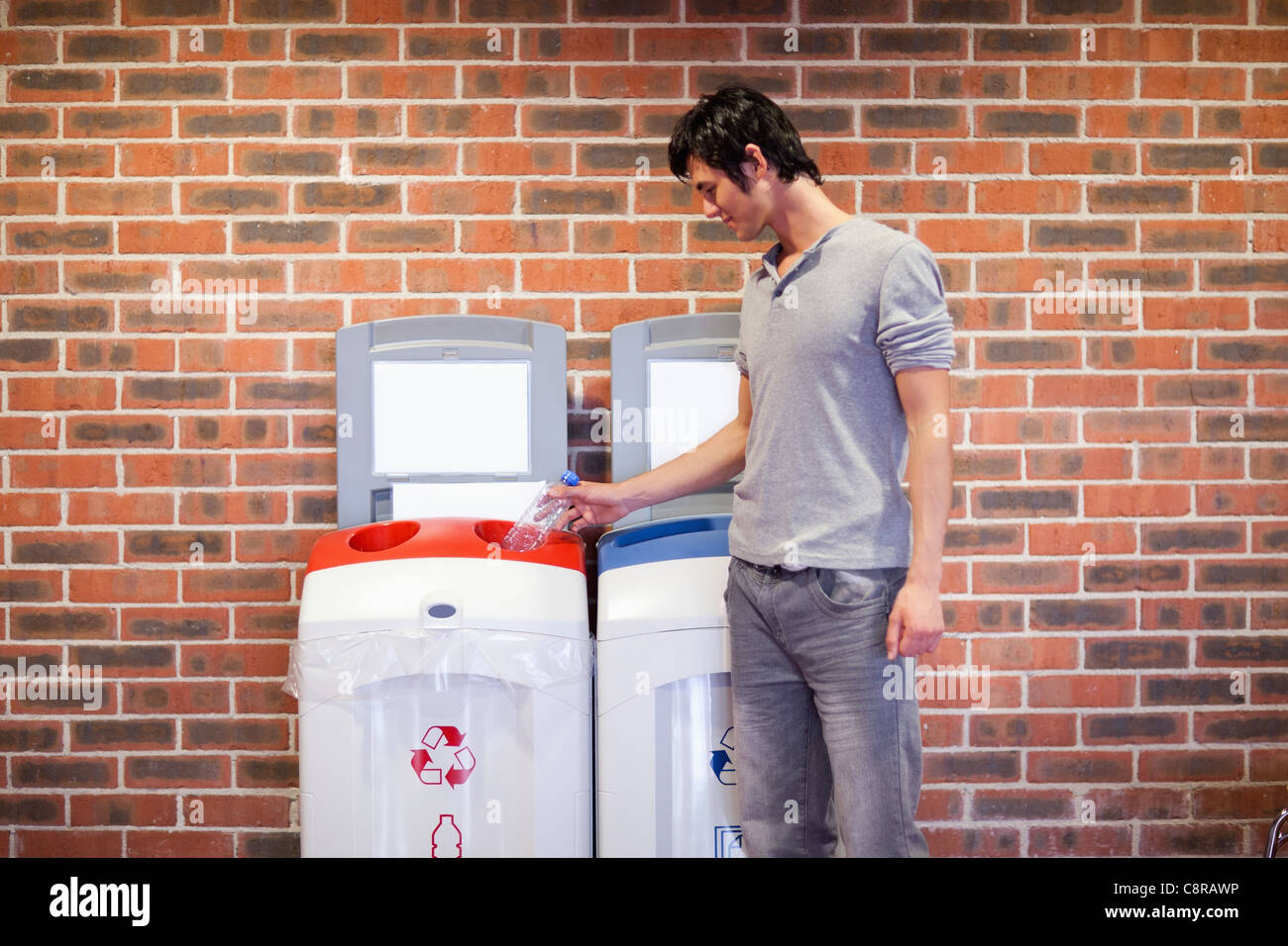 Young man recycling Stock Photo - Alamy