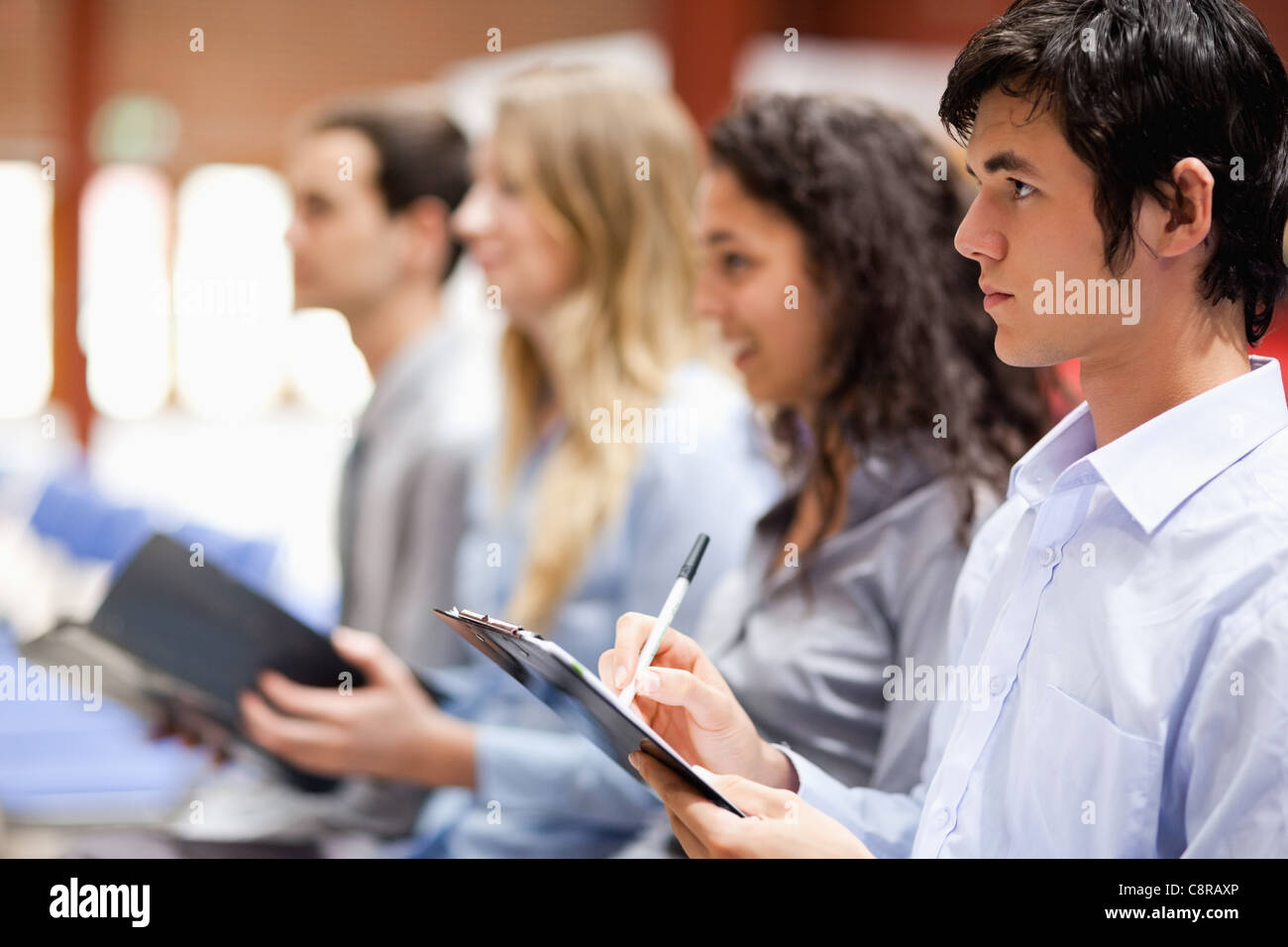 Business people taking notes Stock Photo - Alamy