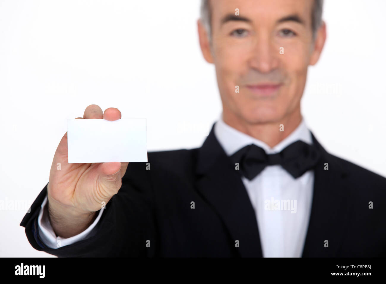 Silver service waiter holding up a business card Stock Photo - Alamy