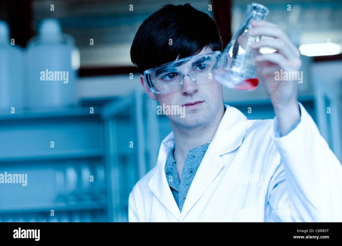 Male scientist looking at an Erlenmeyer flask Stock Photo - Alamy