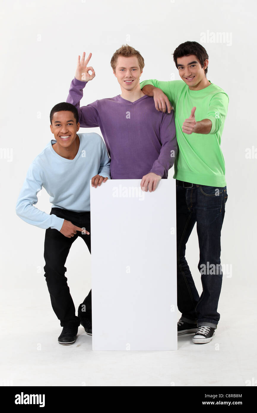 Three students presenting a poster Stock Photo - Alamy