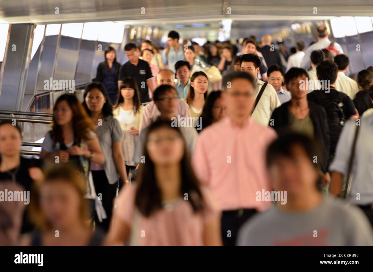 Crowds of Chinese office workers flowing along an elevated walkway in ...