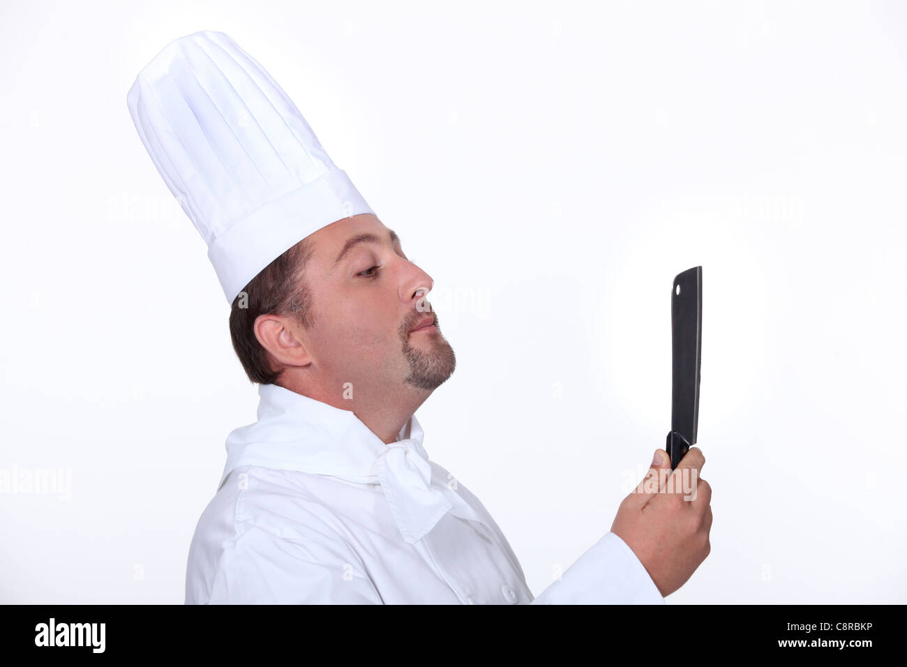 Chef looking at his reflection in a knife Stock Photo - Alamy