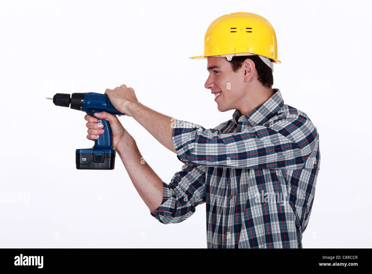 Tradesman holding a power tool Stock Photo - Alamy