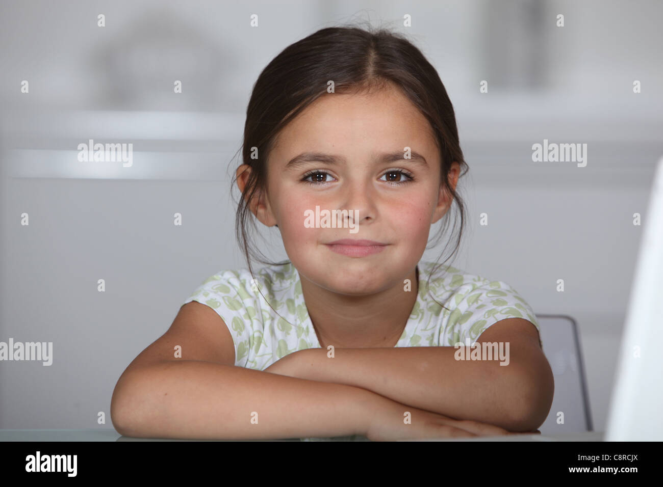 Little girl sat at table Stock Photo - Alamy