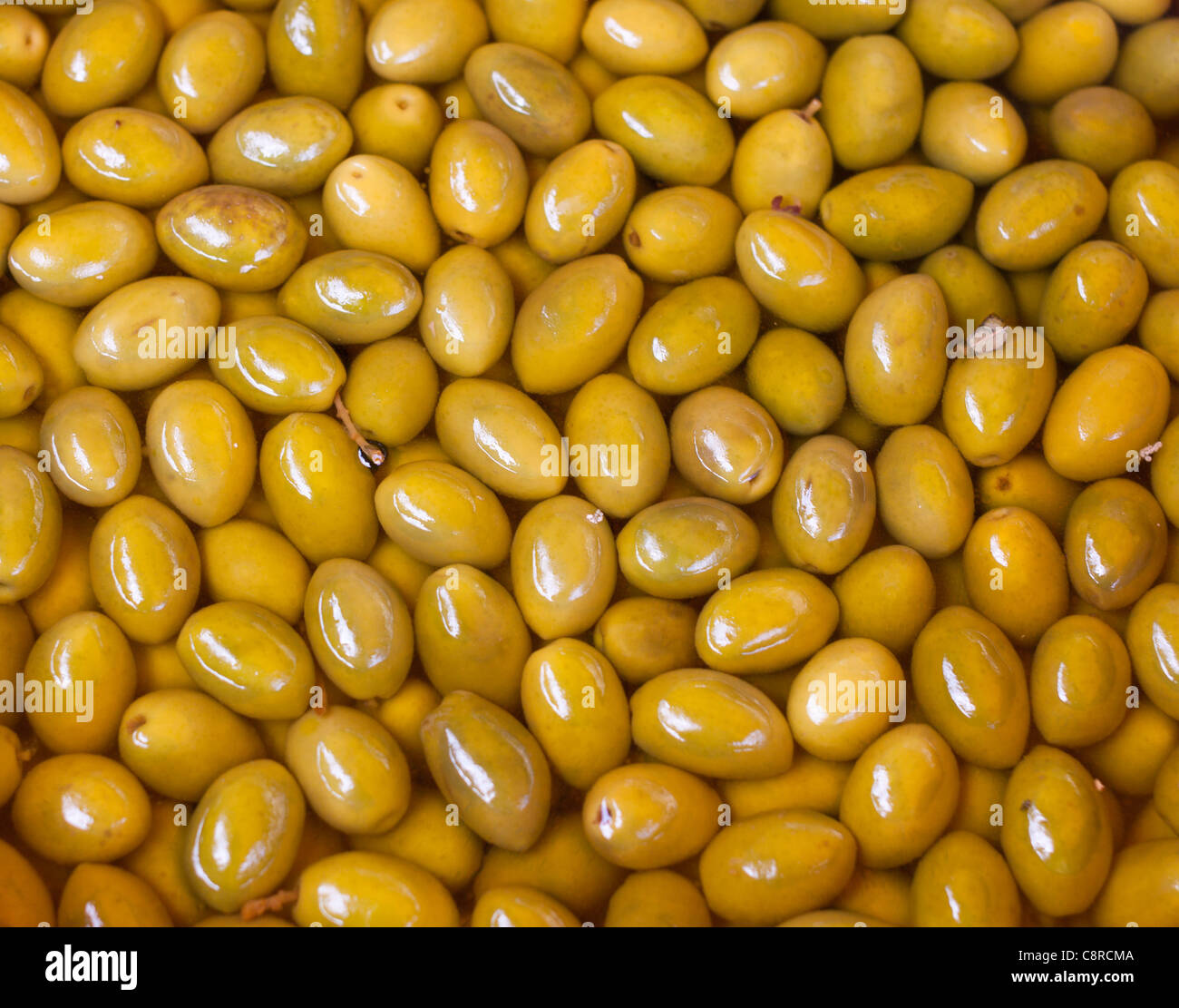 Shiny green olives closeup background Stock Photo - Alamy