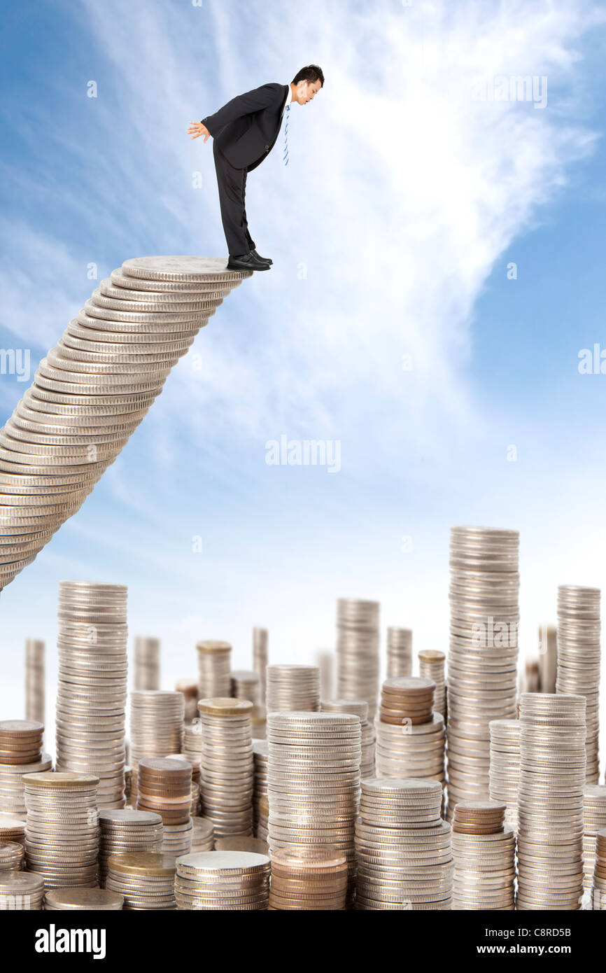 surprised businessman standing on the money stairs and watching many ...