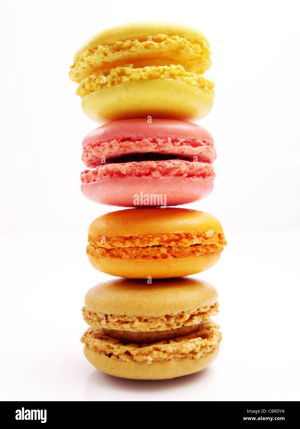 stack of lemon, strawberry, apricot and praline macaroons with a white ...