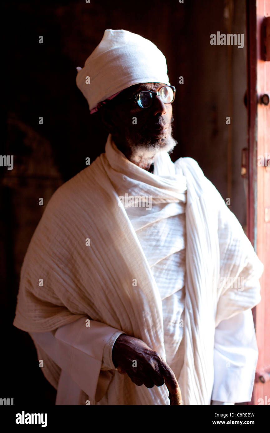 Portrait of an Orthodox Christian priest standing in the doorway at the ...