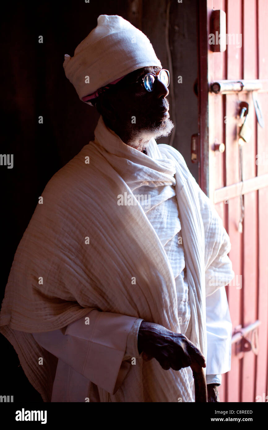 Portrait of an Orthodox Christian priest standing in the doorway at the ...
