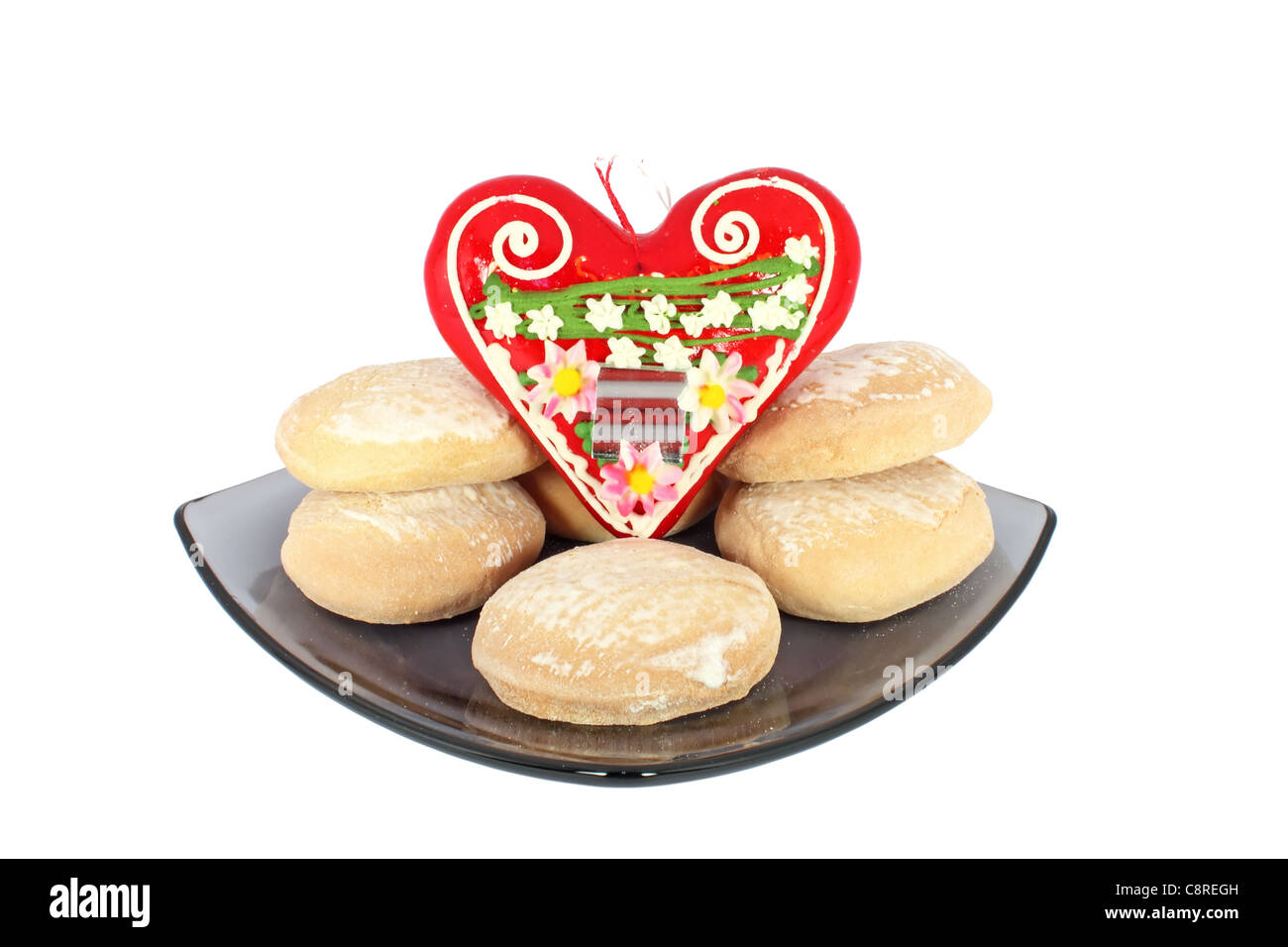 Honey cake and Licitar cookie on black plate isolated on white Stock ...