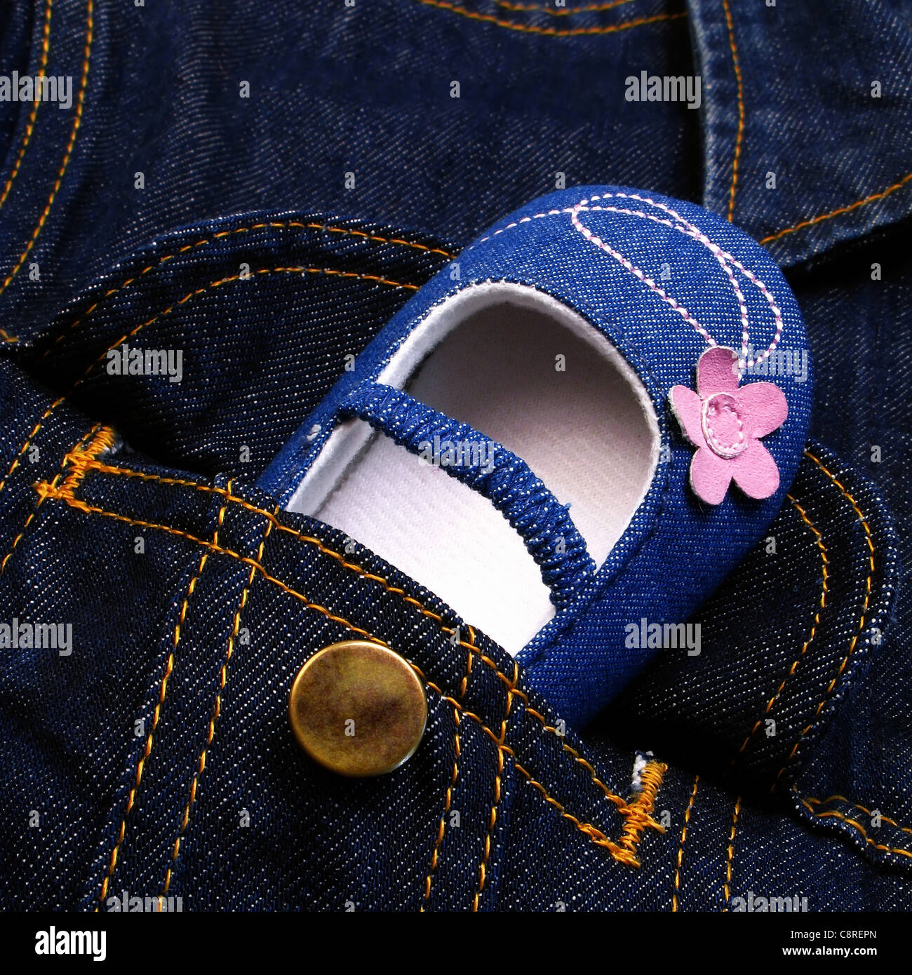 baby shoe in the pocket of a denim jacket Stock Photo - Alamy