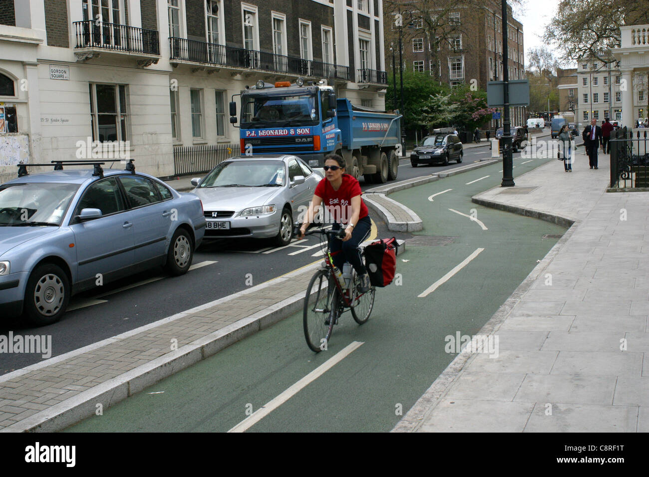 cycling on designated bike path through busy street of London Stock ...