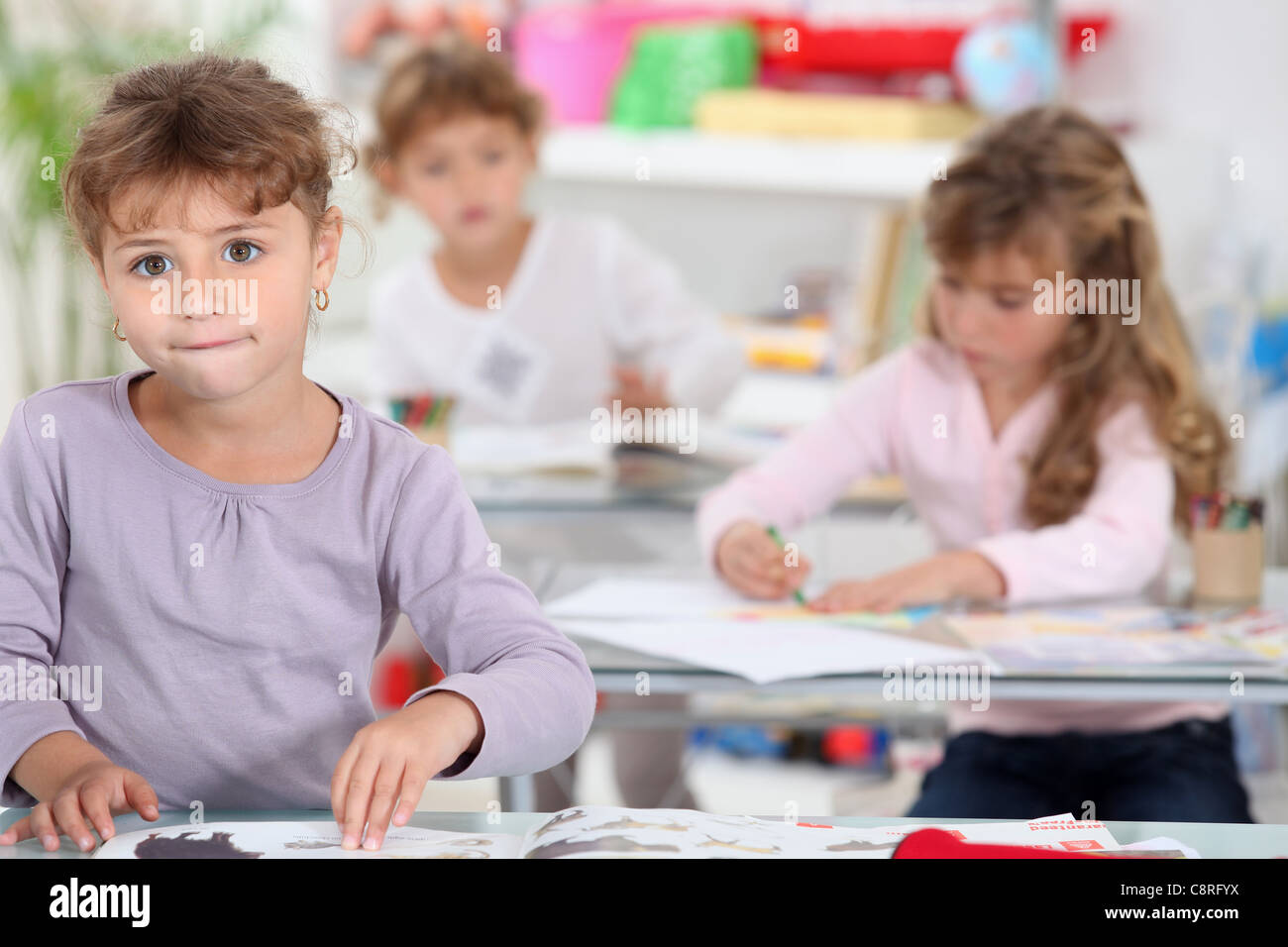 Three little girls in class Stock Photo - Alamy