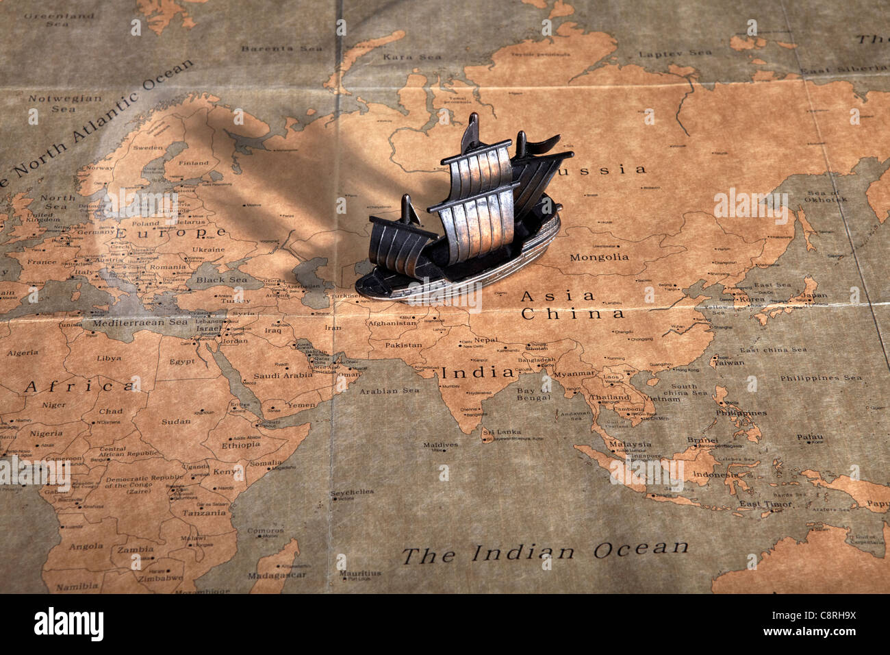 Boat Model With The World Map Stock Photo - Alamy