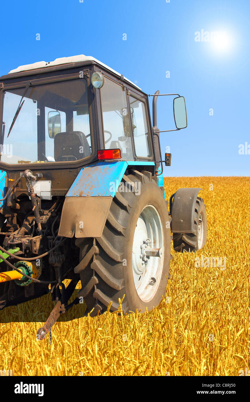 Tractor in a field, agricultural scene in summer Stock Photo - Alamy