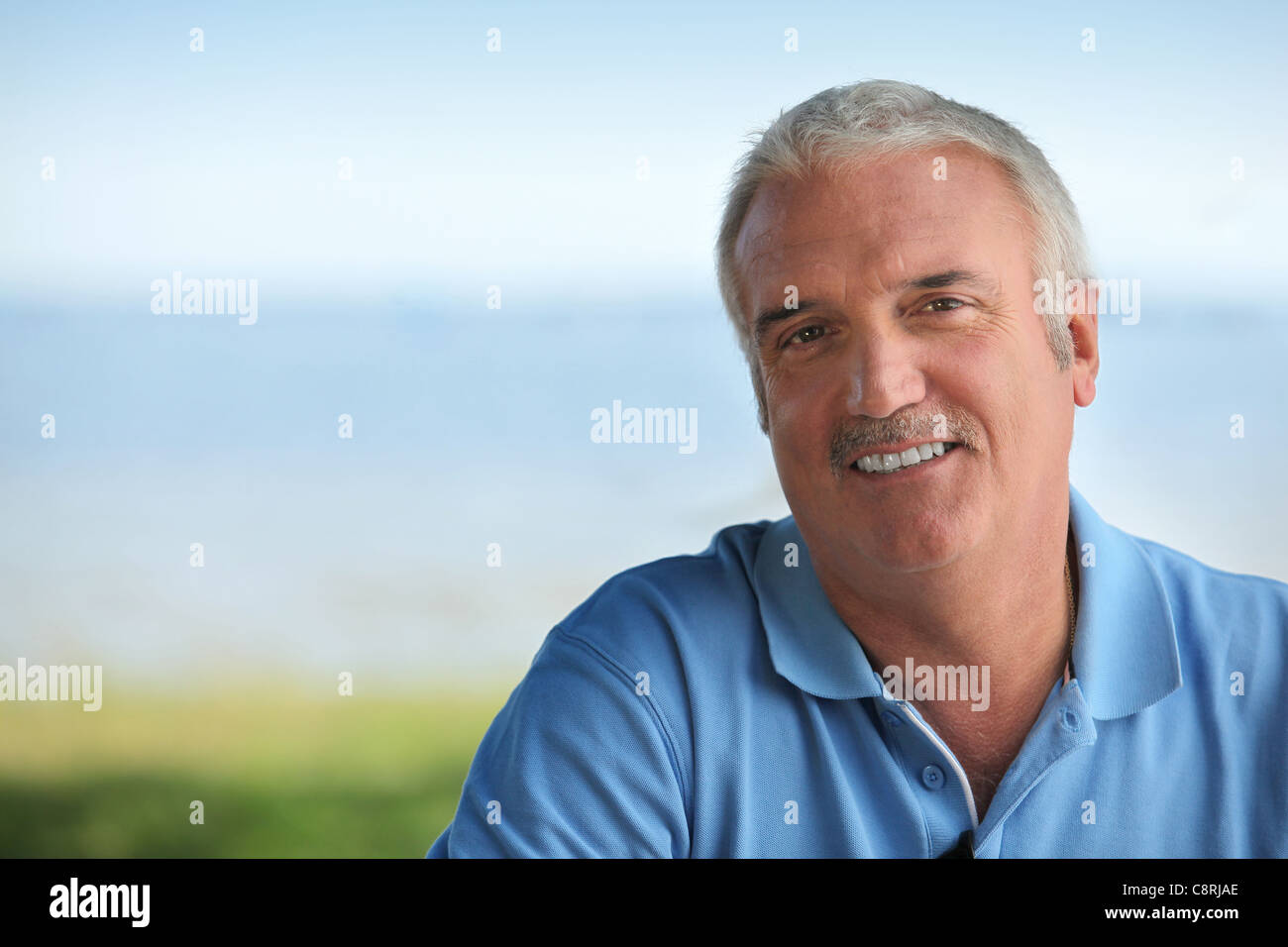 Man wearing blue polo Stock Photo - Alamy