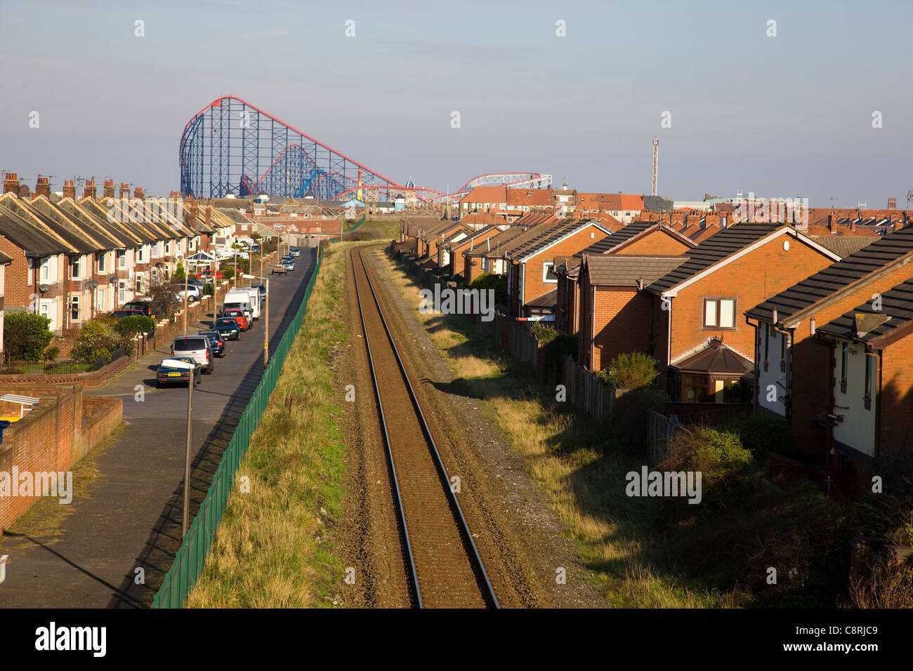 Railway line and rows of houses overshadowed by "The Big One" roller ...